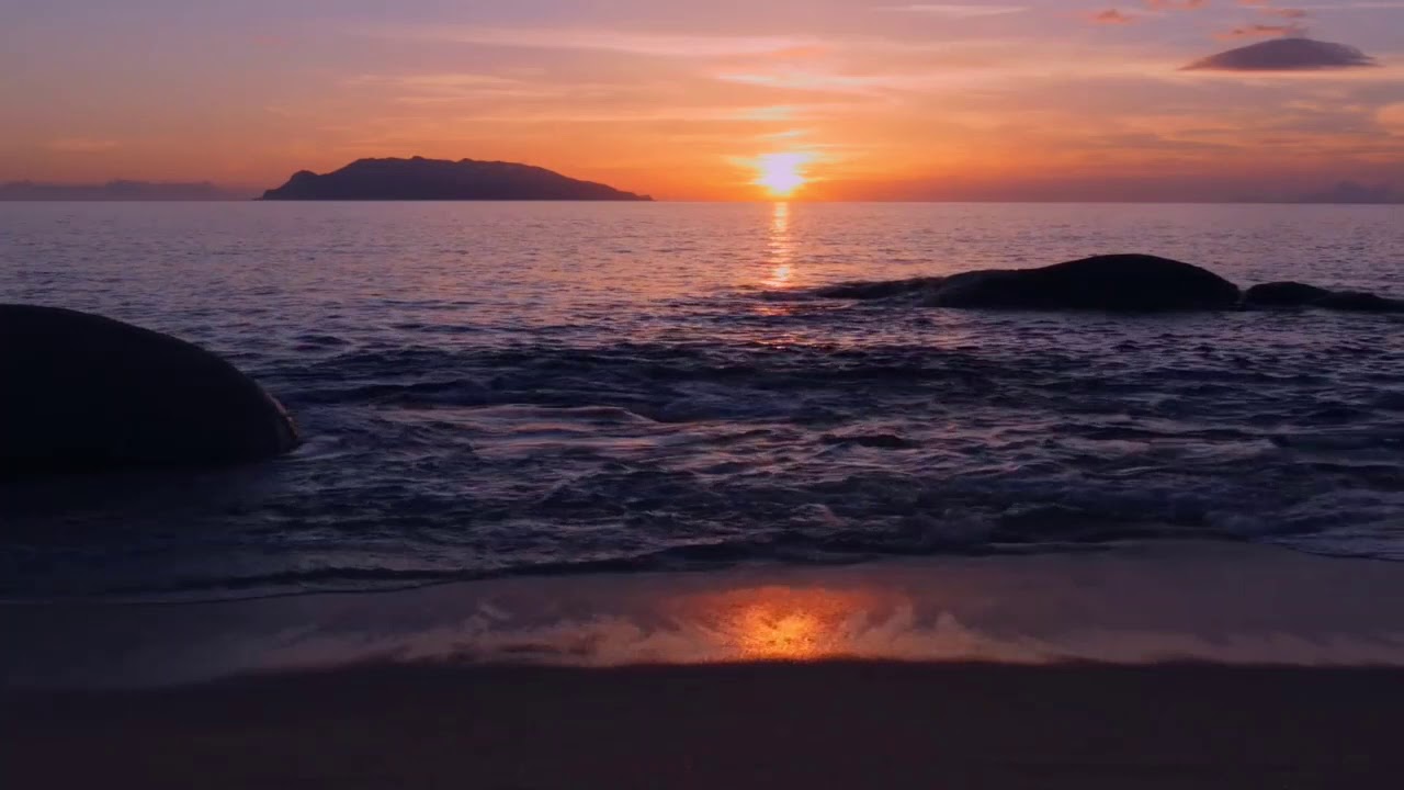 Relaxing sunset over the beach with soft relaxing music and the sound ...