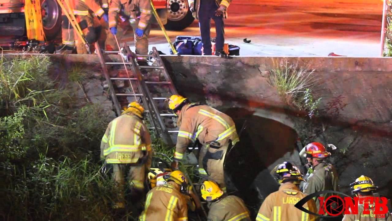 Fire crews rescue man from water filled ditch - YouTube