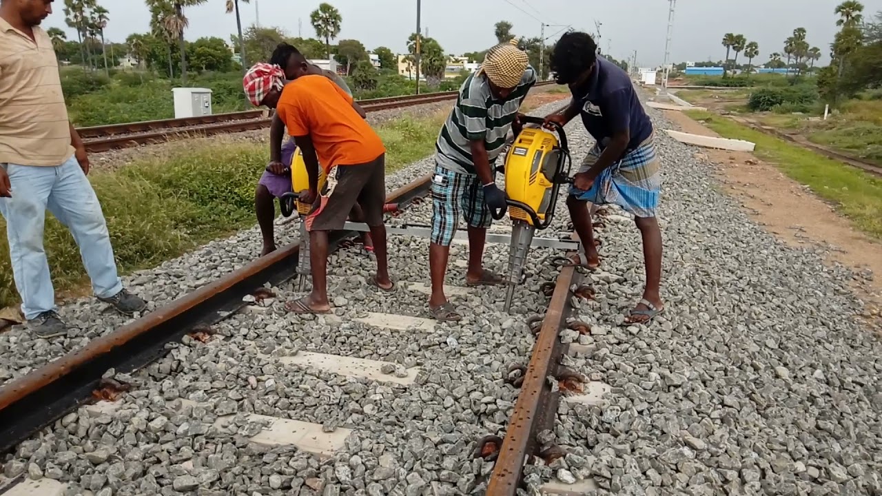 Railway track ballast packing work with small machine - YouTube