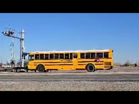 School buses stopping for railroad grade crossing. All size buses ...