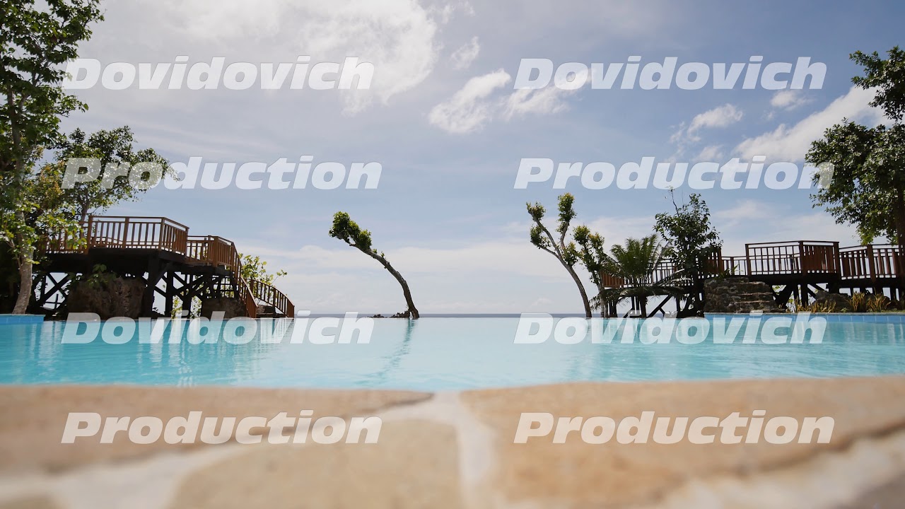 Outdoor swimming pool in an exotic country. Recreation near the ocean ...
