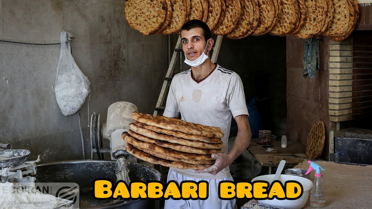 The high speed of the baker in baking delicious Berber bread in Iran ...