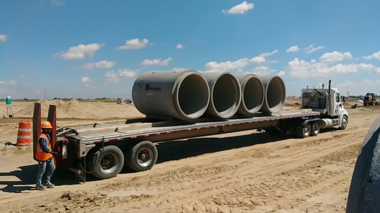 Sewer pipe rolling off of Flatbed - YouTube