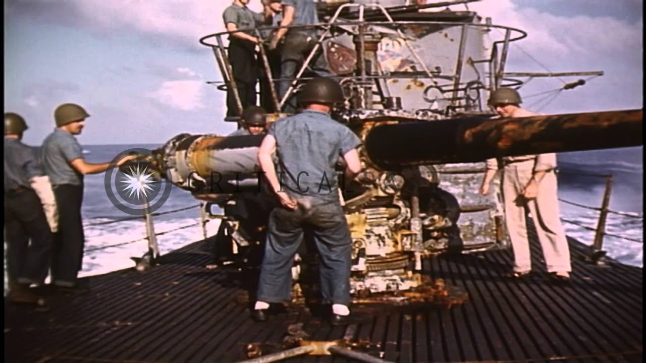 Sailors manning battle stations and fire guns aboard USS Barb submarine ...