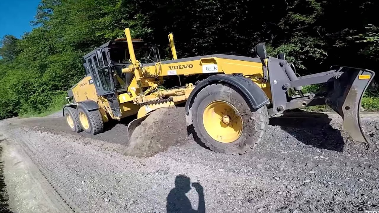Motor Grader Grading Ground Asphalt Behind The Cold Planer-Skilled ...