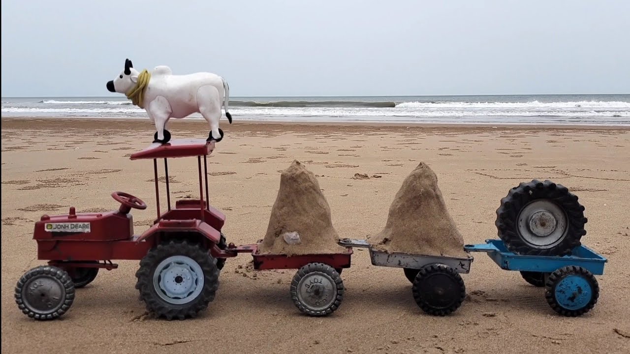 Mini tractor loading bull,sand and tyres - YouTube