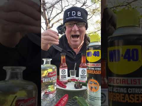 Guy eats hot peppers covered in hot sauce...