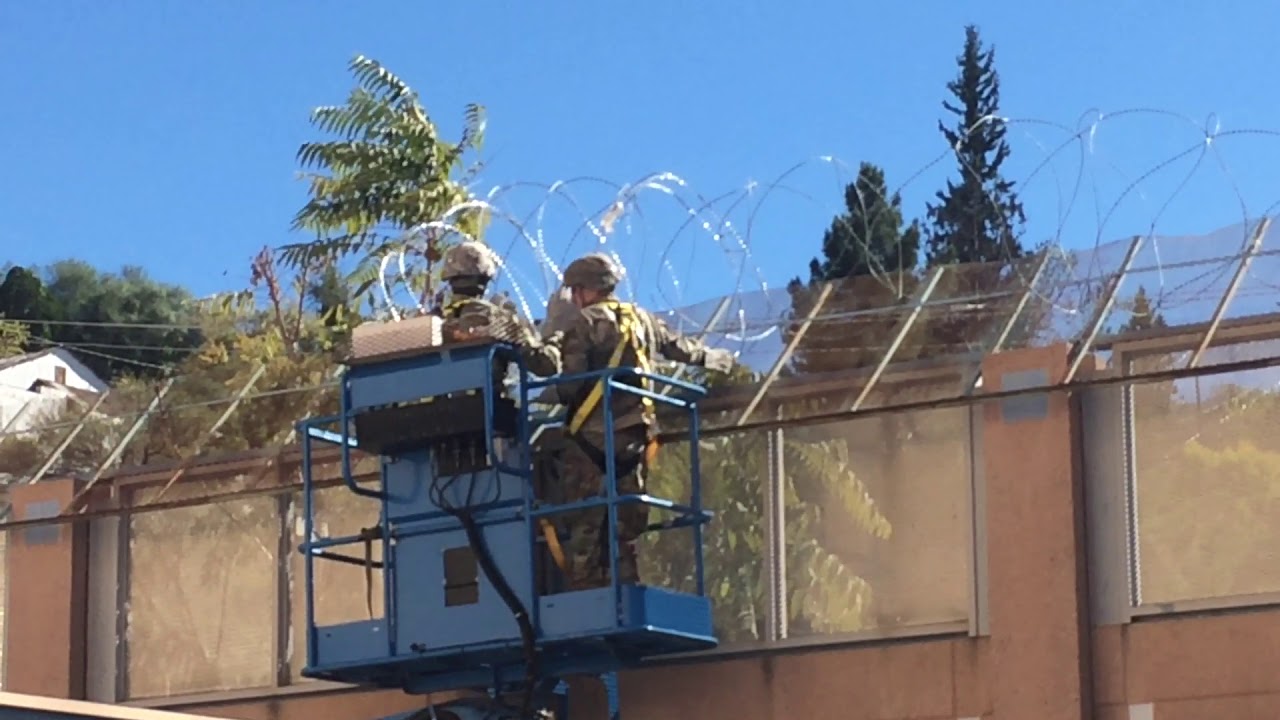 Troops install razor wire on border - YouTube