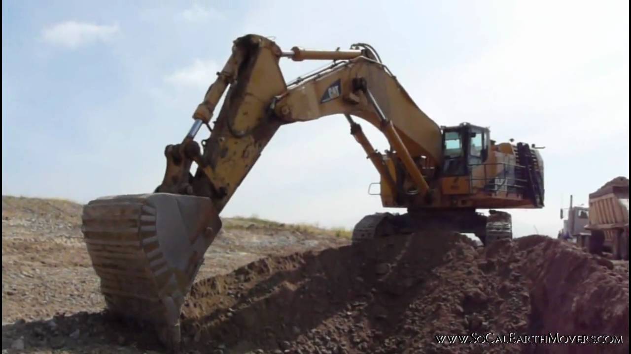 CAT 5110B loading bottom dumps - YouTube