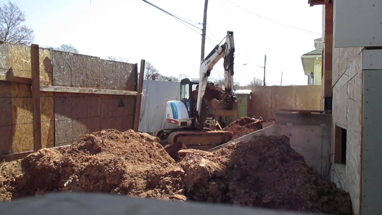Excavator Backfilling Trenches - YouTube