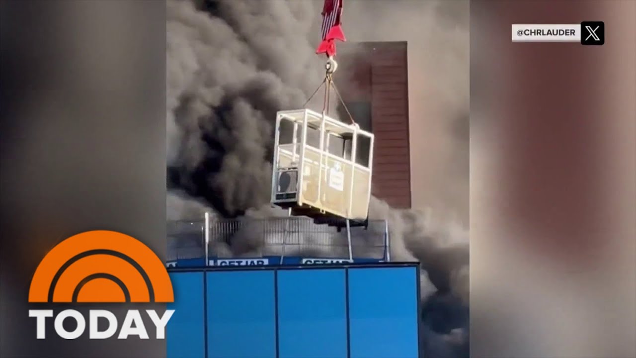 Watch: Crane operator rescues worker from burning high-rise - YouTube