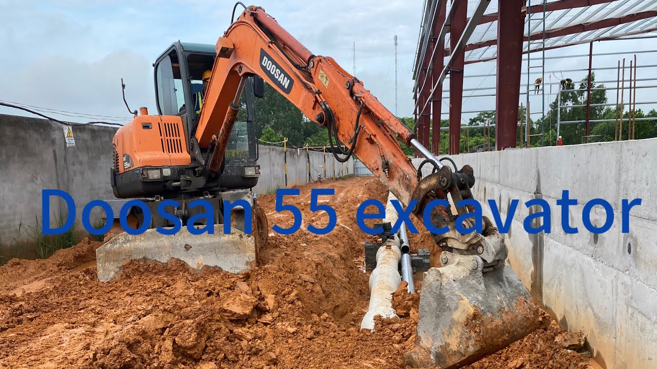 Doosan 55 excavator works at the construction site - YouTube