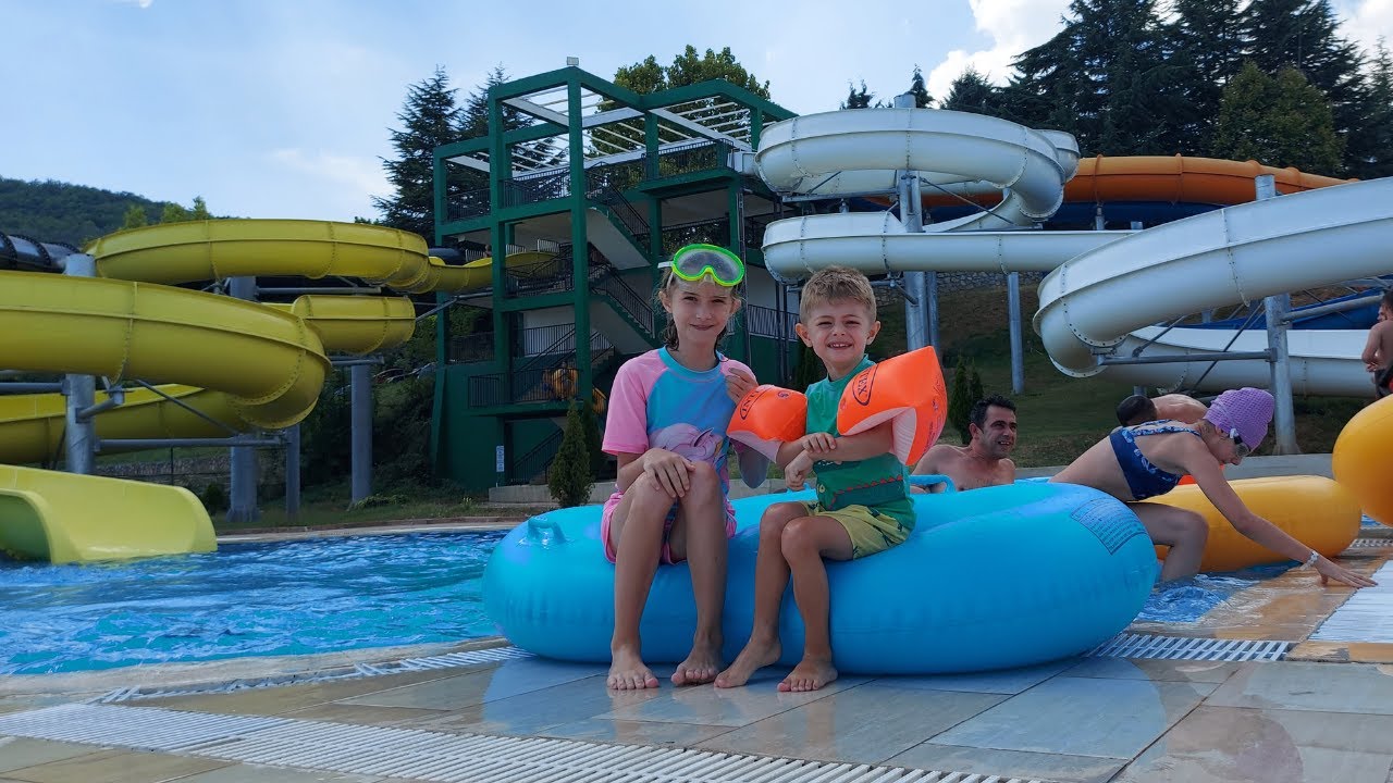 Slide for kids in water park - Aquapark fun day at the pool kids play ...