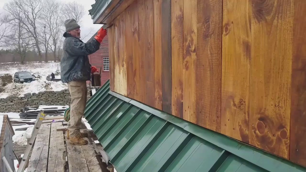 applying homade wood preservative to barn board - YouTube