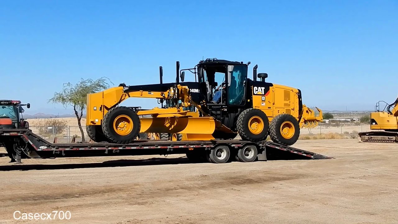 Unloading a NEW CAT 140M SERIES 2 GRADER - YouTube