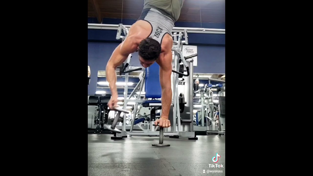 One handed handstand and spinning a dumbell with the other hand. - YouTube