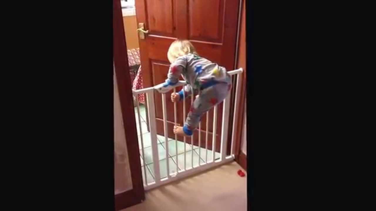 Toddler learns to climb over safety gate for the first time - YouTube
