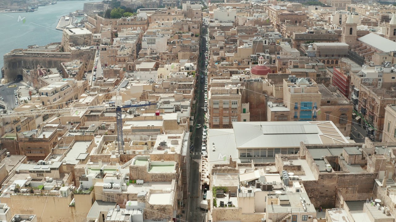 Above the Rooftops of Valletta, Malta Capital City tilt down to Aerial ...