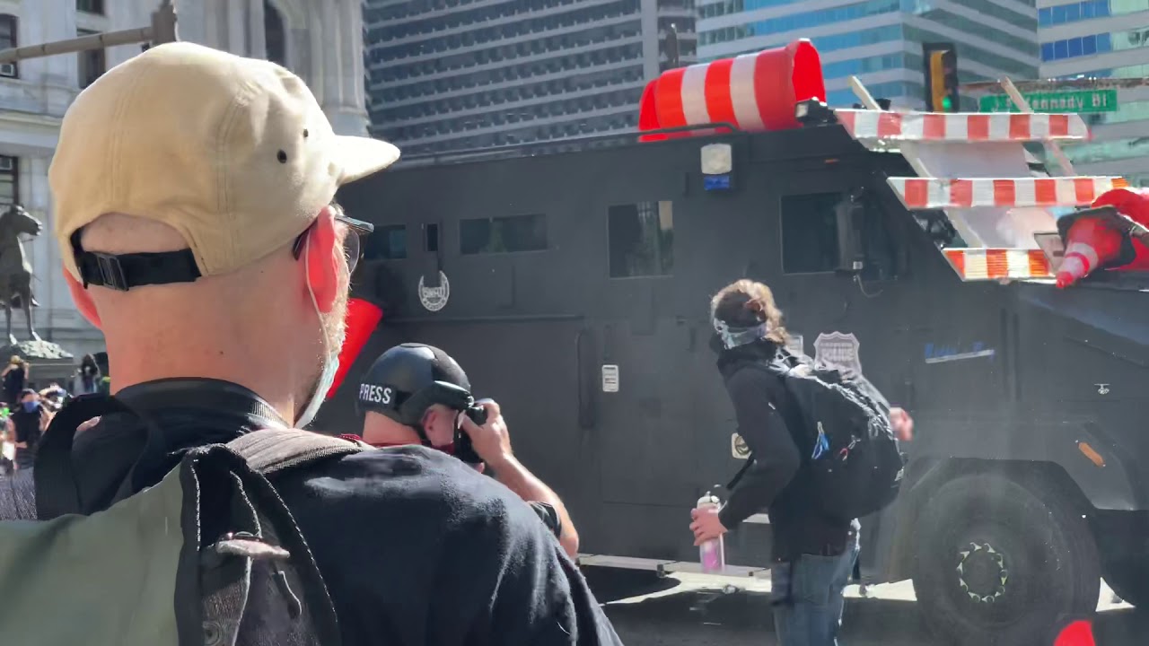 Watch protesters try to stop a swat vehicle - YouTube