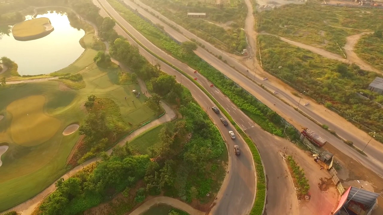 Aerial Stock footage India Top-shot Cars Rolling down the Golf course ...