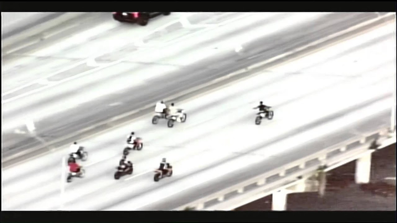 Dirt bike riders pop wheelies on Miami expressway - YouTube