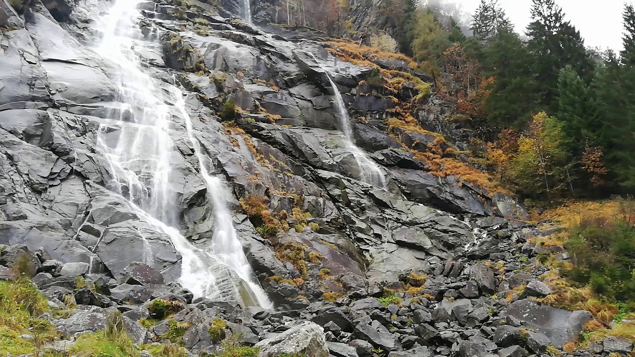 A Waterfalls Cascading Down Through The Sides Of A Mountain Rock - YouTube