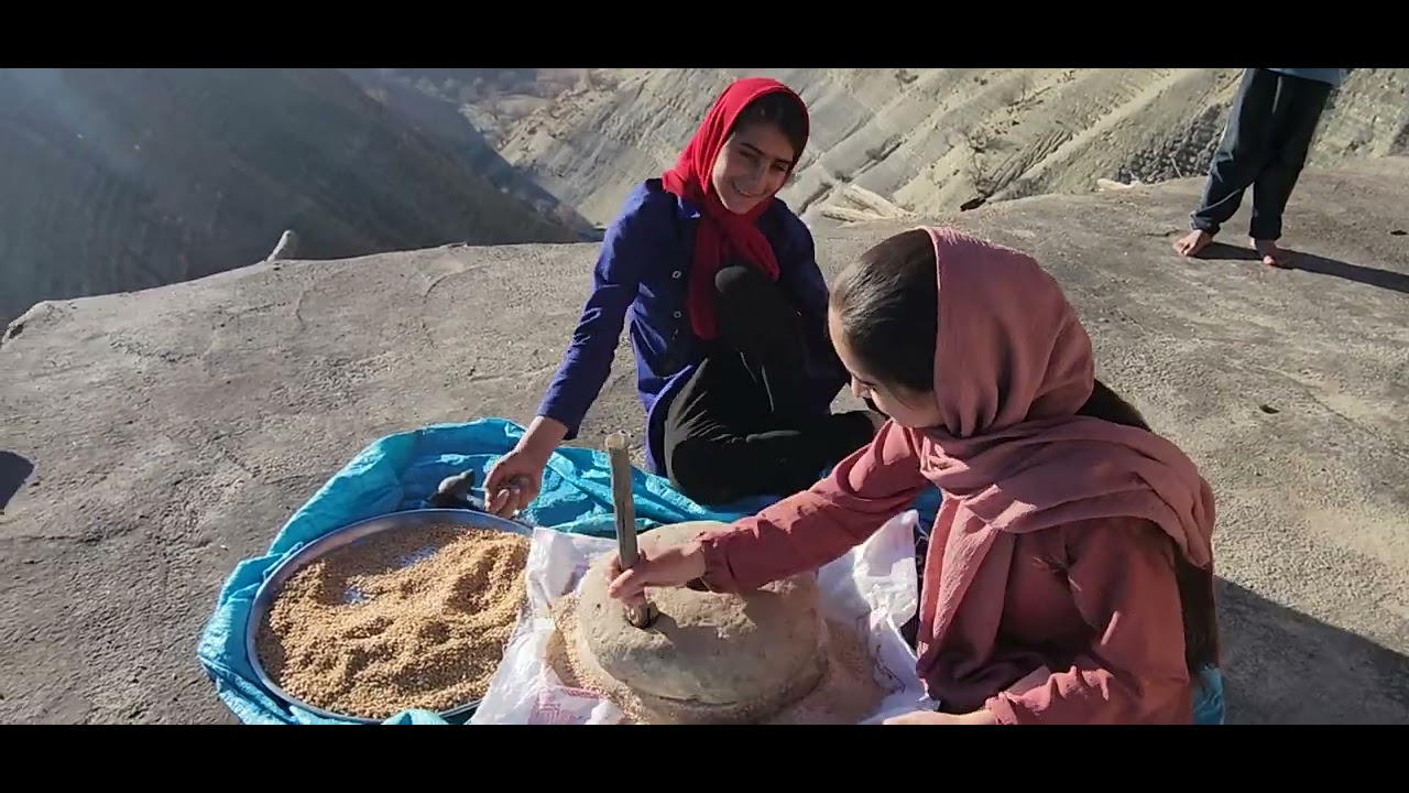 Grinding wheat in the traditional way of manual grinding - YouTube