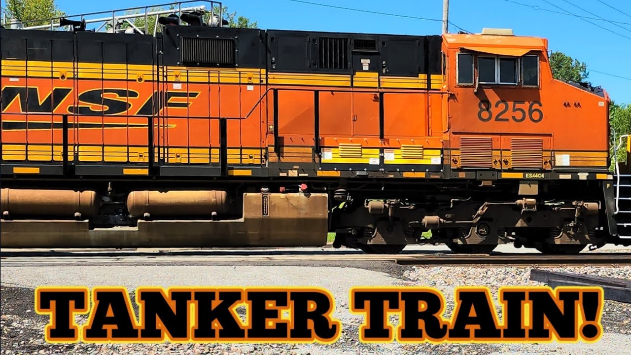[4K] A BNSF DUO LEADS AN EMPTY ETHANOL TRAIN PAST A STACK OF RAILROAD ...