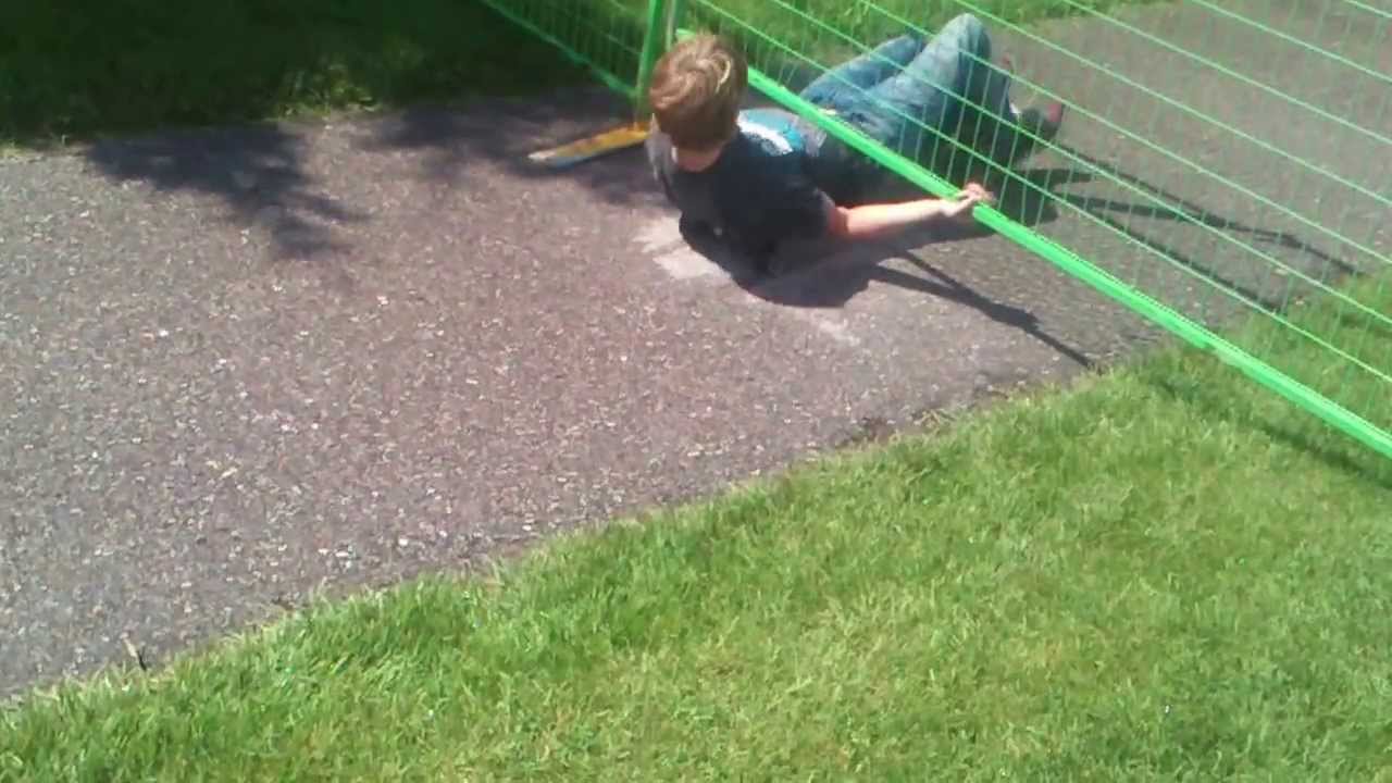 Kid gets stuck under fence on a longboard - YouTube
