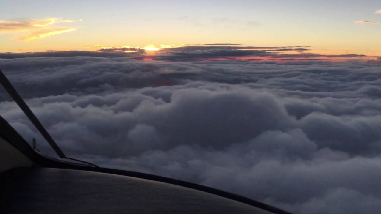 Descending through clouds at sunset - YouTube