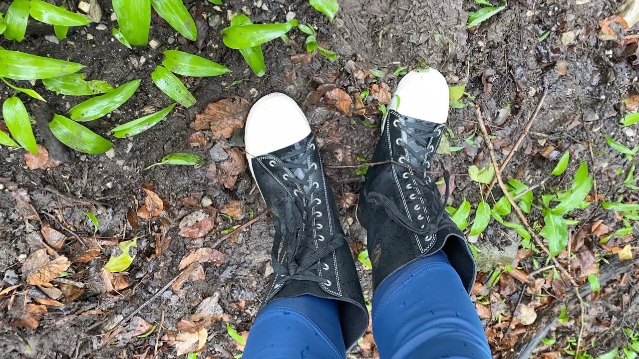 Laced black rain boots in deep mud - YouTube