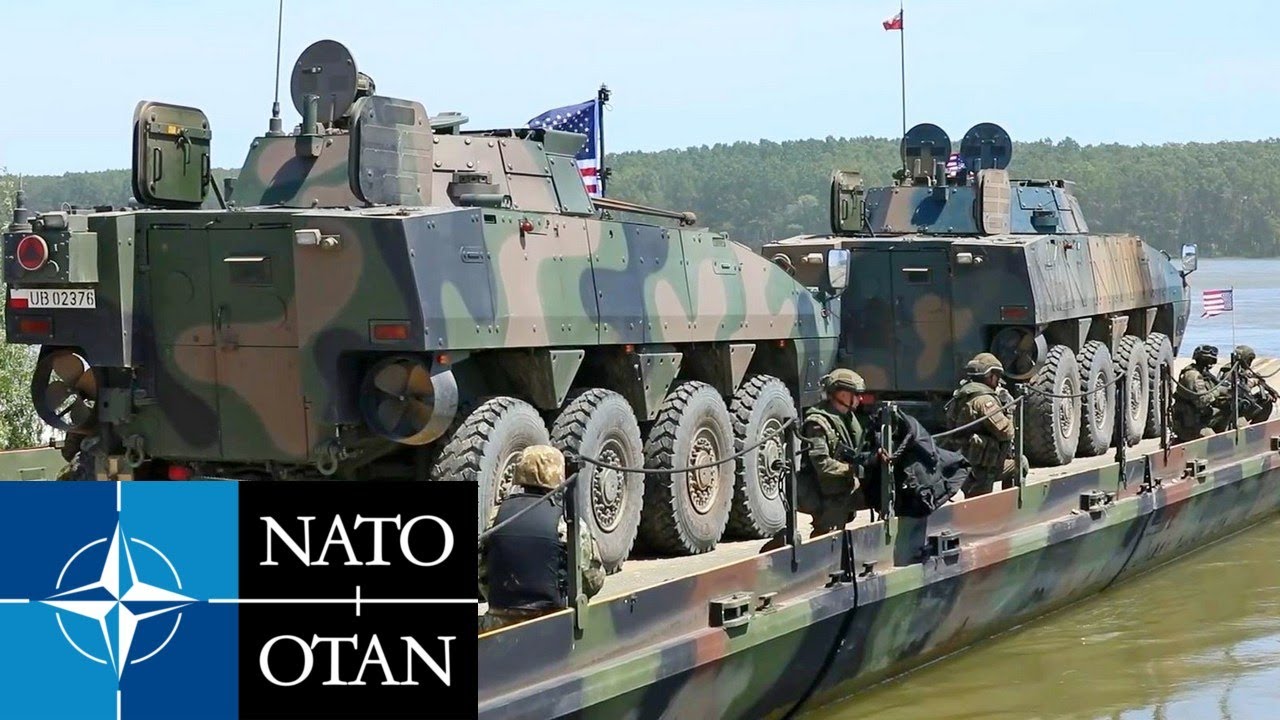 NATO. Powerful Armored Vehicles Cross the Danube River in Romania ...