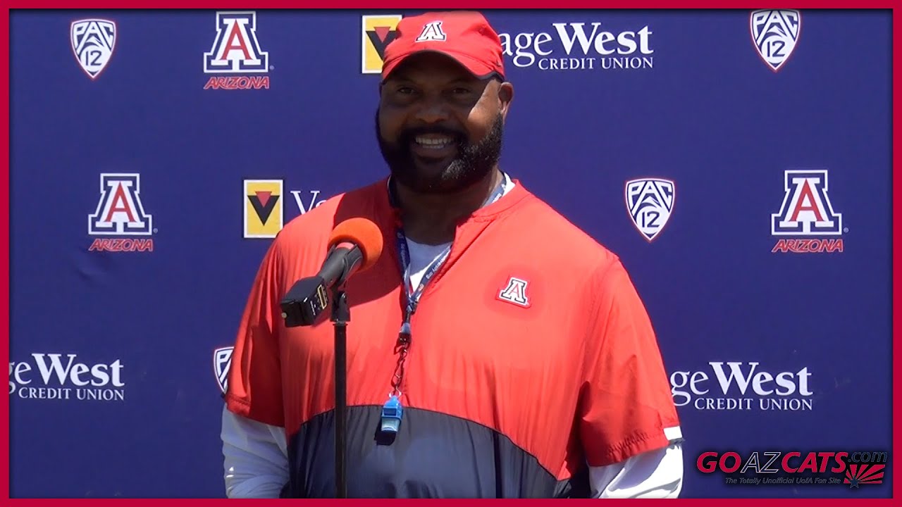 Defensive line coach Ricky Hunley talks after Arizona's camp practice ...