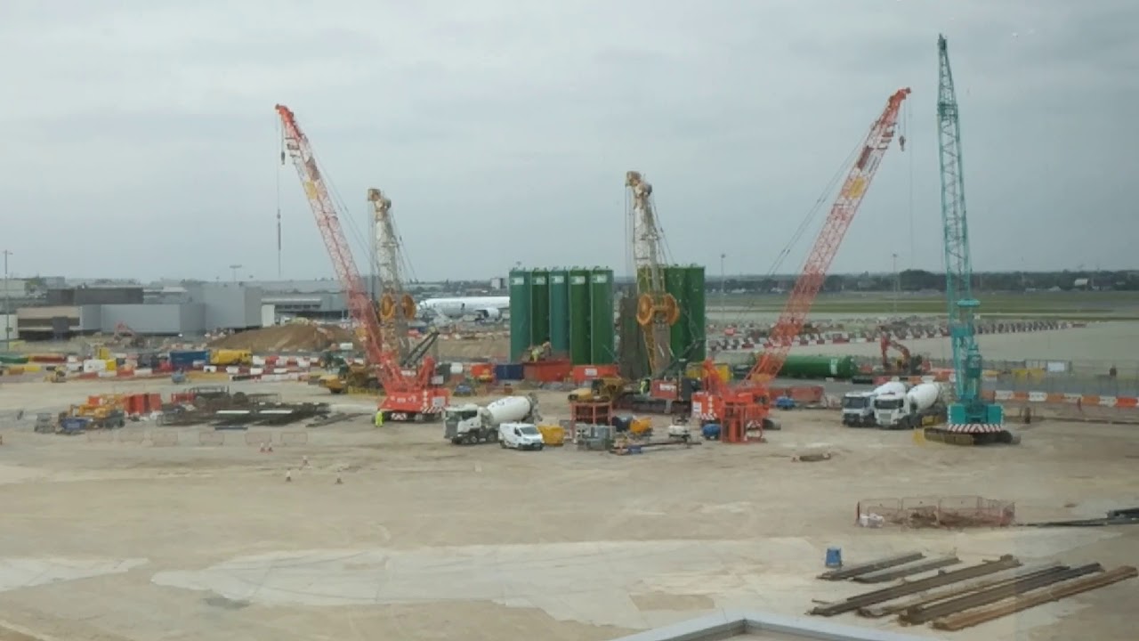 Crane digger in London's Heathrow airport. Watch the centre crane ...