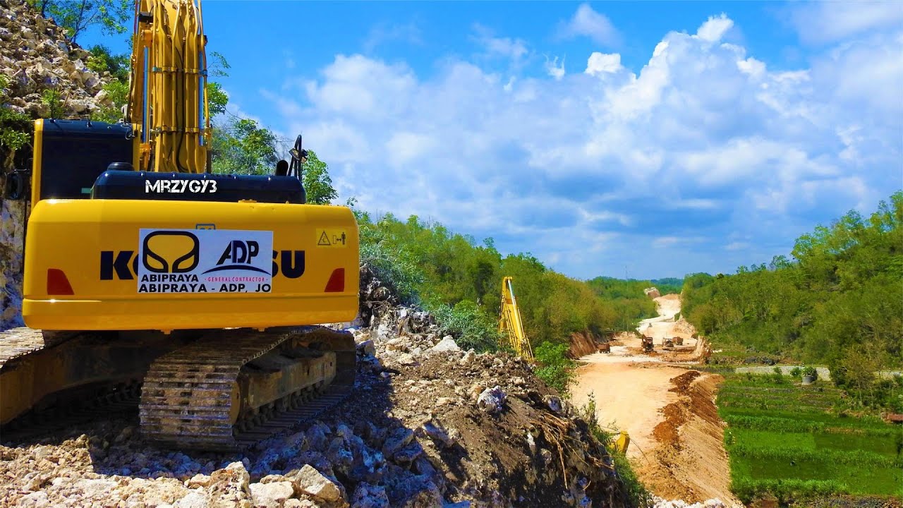 Excavator And Dump Trucks Excavating Limestone On The New Road Work ...