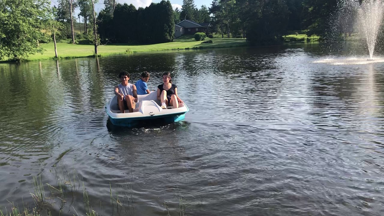 Boat peddling on a calm pond - YouTube