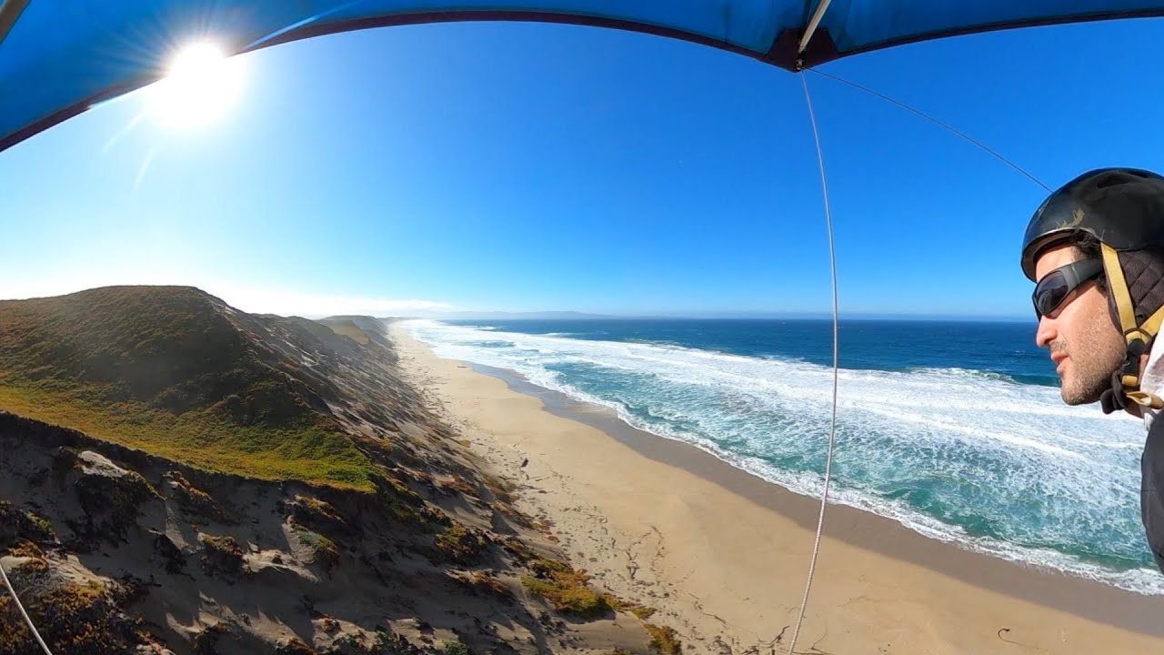 Skimming the dunes in a hang glider - YouTube