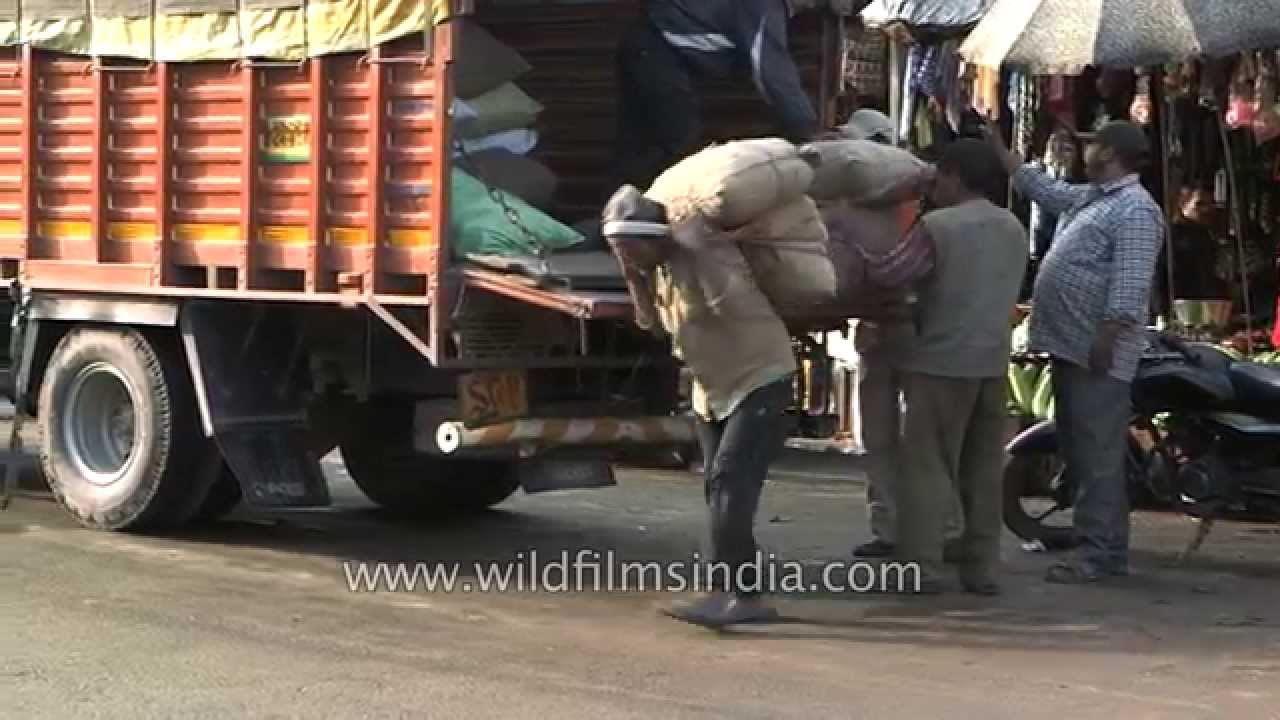 Workers unloading goods from a loaded truck in Lohaghat - YouTube