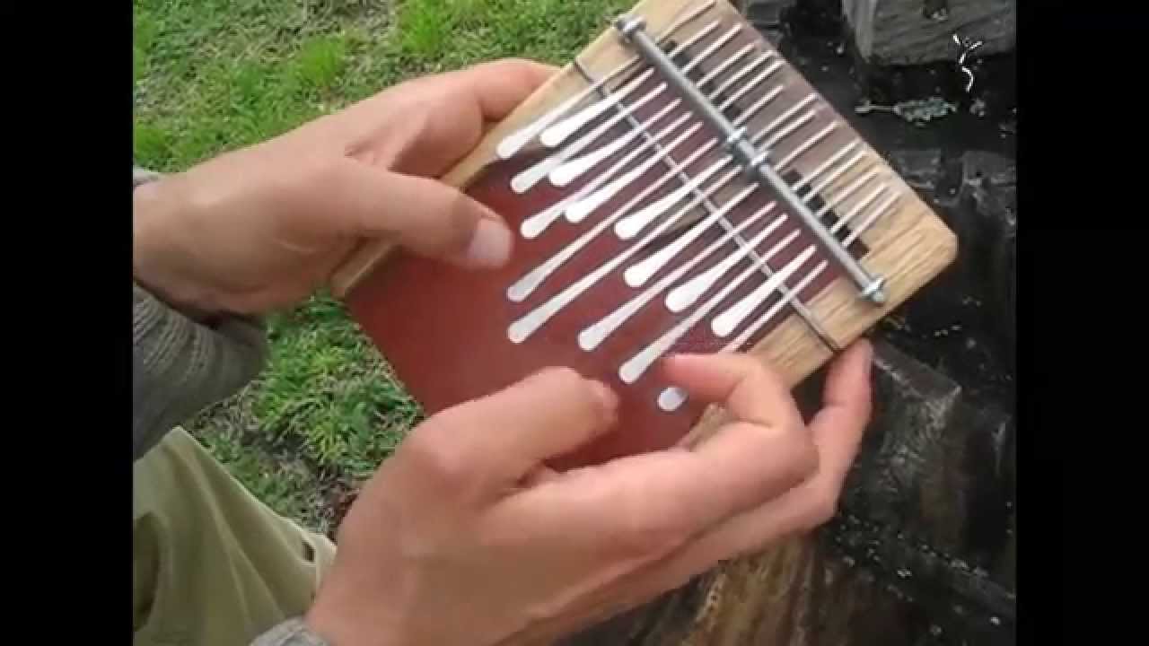 Vincent Hickman playing a Roots Production kalimba at the Château-Vieux ...
