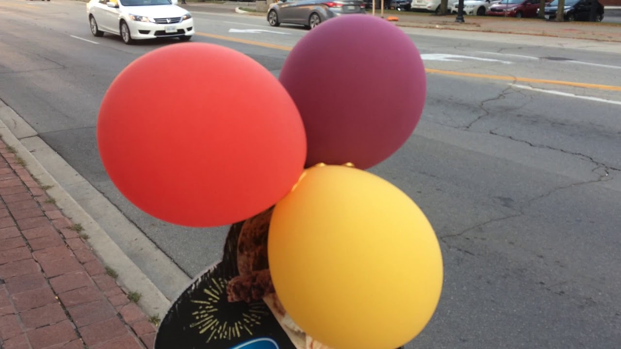 Balloons on a sign - YouTube