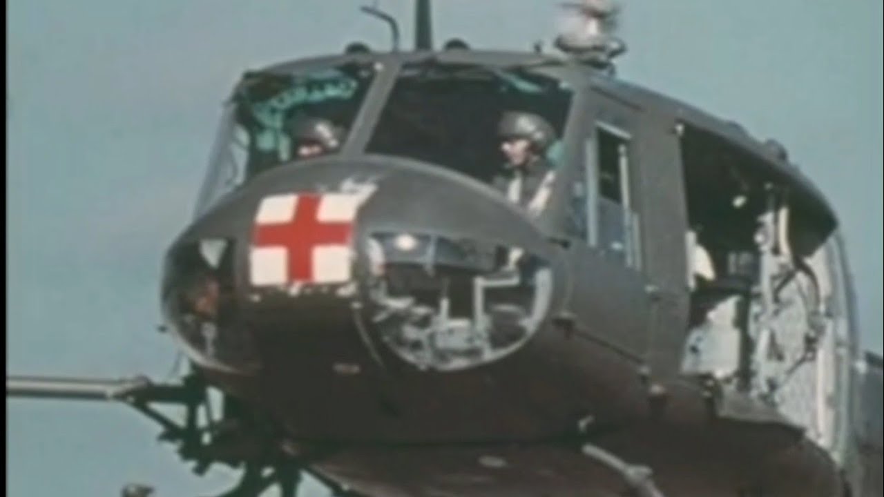 U.S.Army HH-1D Huey crash/rescue helicopter and fire medics in action ...