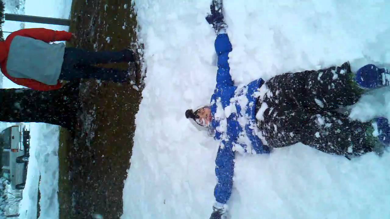 Jackson getting a snow angel picture taken. - YouTube