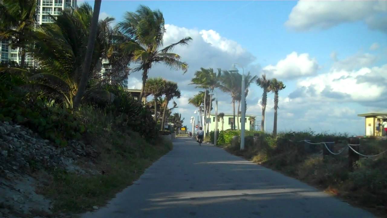 2 NANCY ON PHONE RIDING TANDEM ON HOLLYWOOD BEACH 013012 GREG STENGEL ...