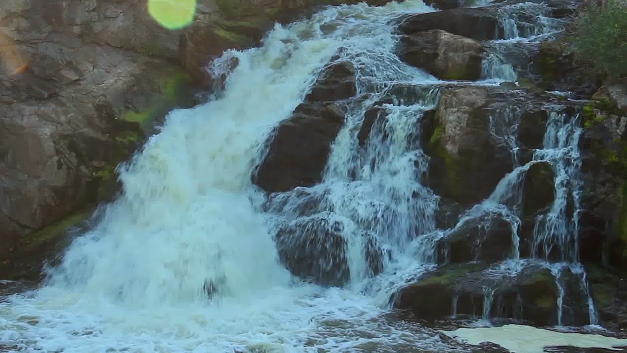 Close-up of turbulent waterfall, stream running down the slope. Stock ...