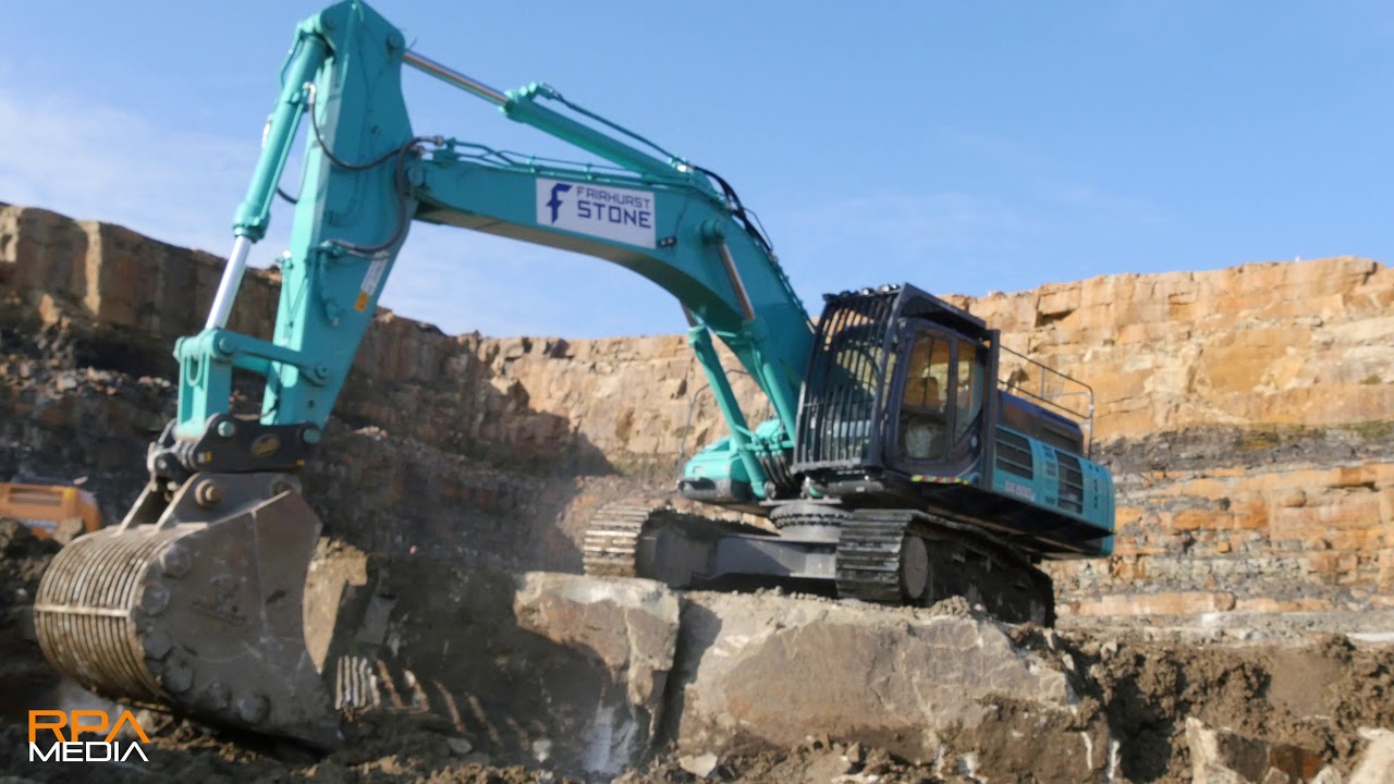 Kobelco SK500 digging block stone - YouTube