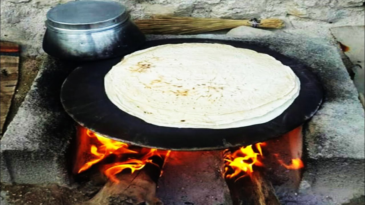 Baking bread on fire.| Baking bread in the village Baking bread on ...