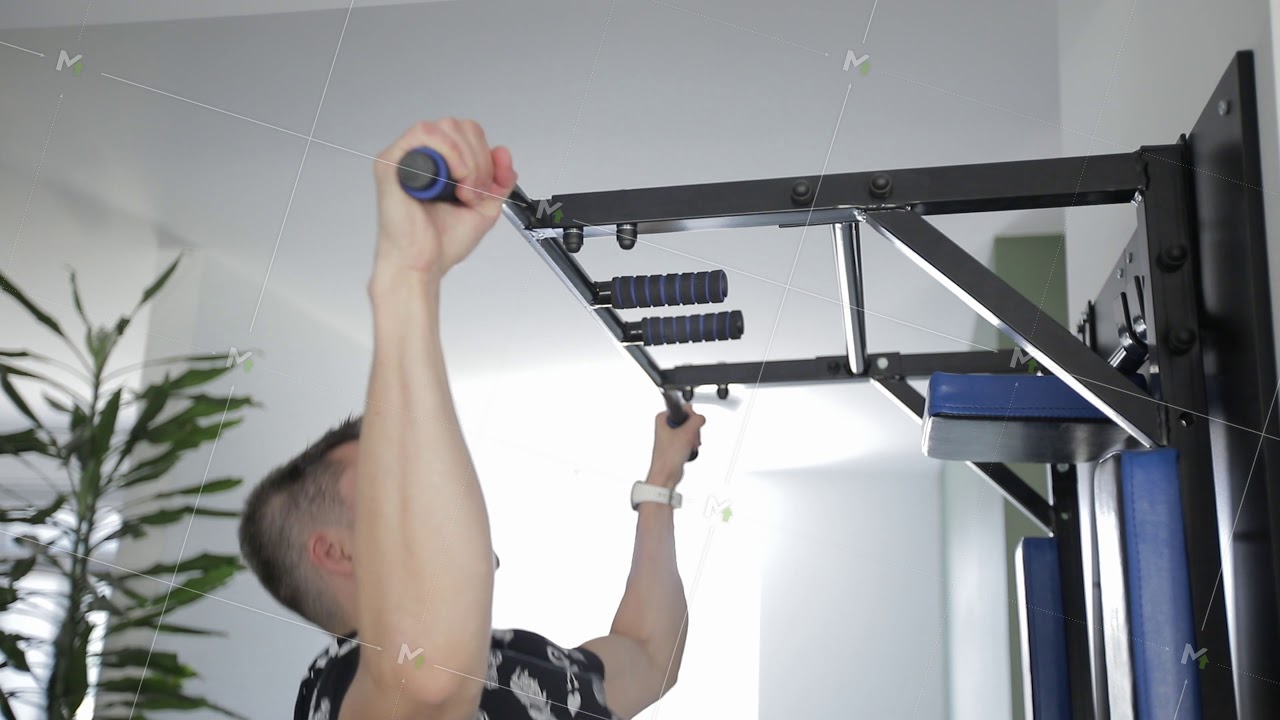 A strong man trains pull-ups. Pull-up exercise in the gym or office for ...