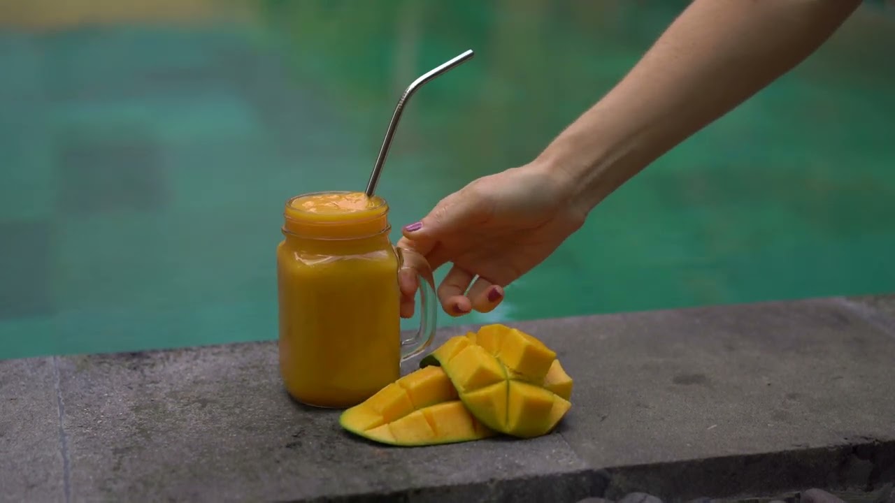 Closeup Shot of a Glass of a Mango Shake and Cut Mangoes FREE STOCK ...