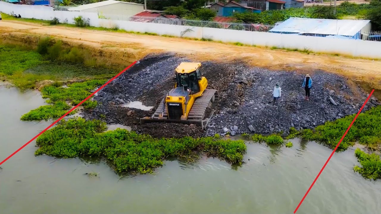 Fast Work Machines Bulldozer And Super Truck Pouring Stone In Deep Pond ...