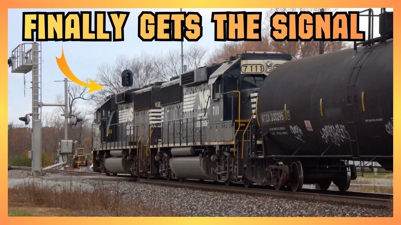 The local waits patiently for the signal as two Eastbound trains get ...